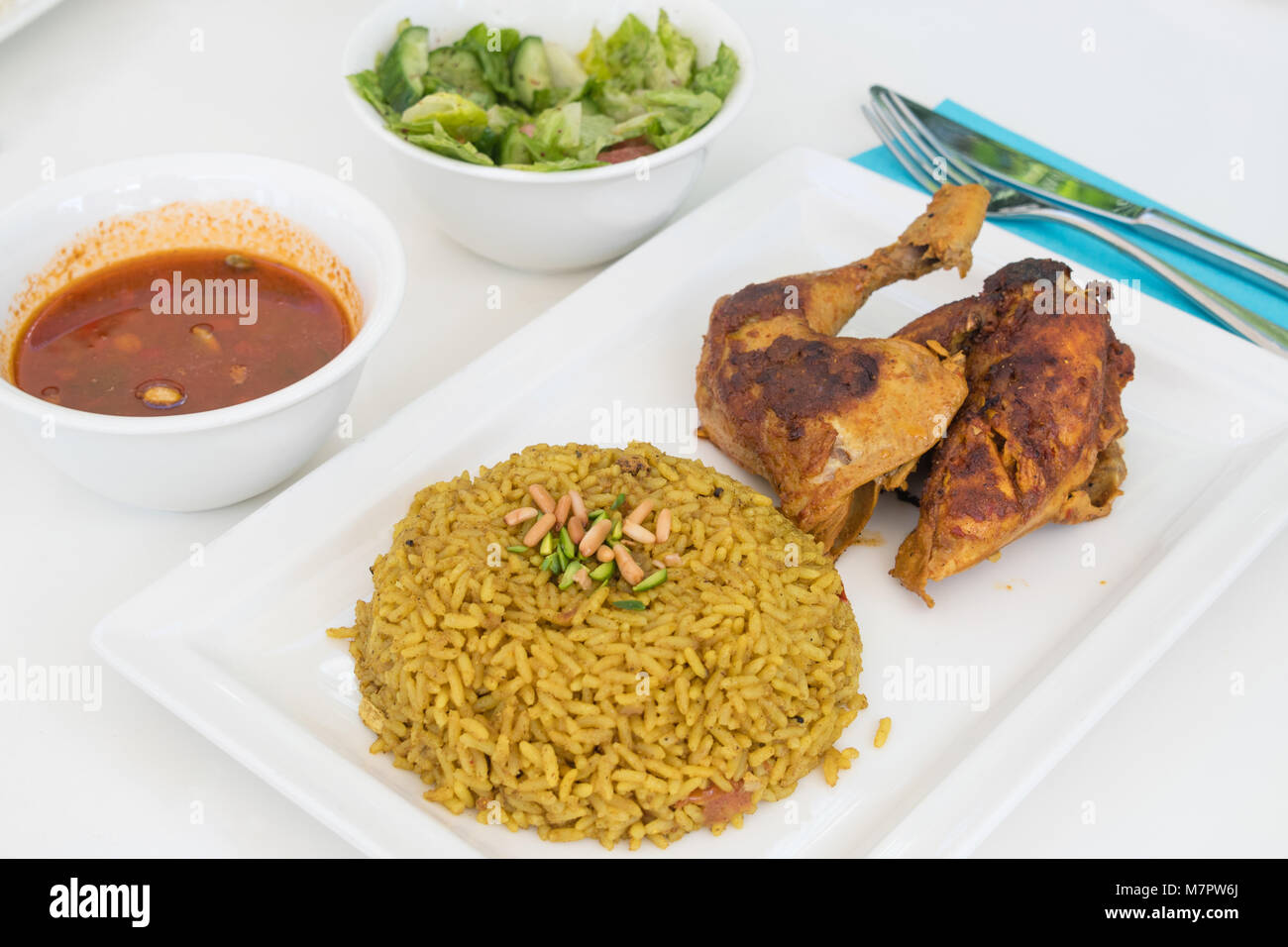 Fried chicken legs with rice accompanied with vegetable salad Stock ...