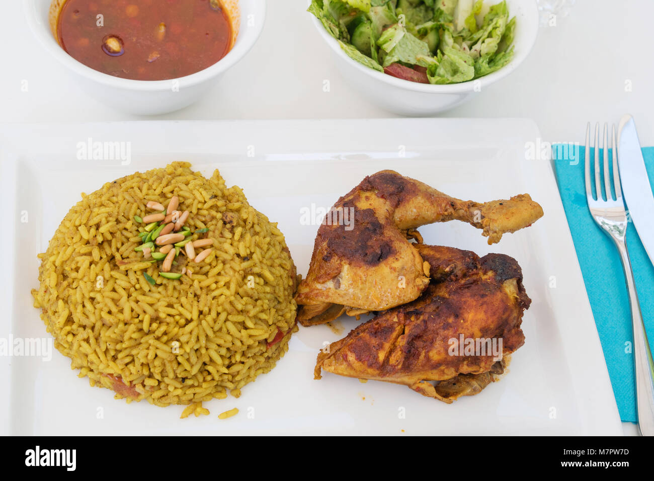Fried chicken legs with rice accompanied with vegetable salad Stock ...