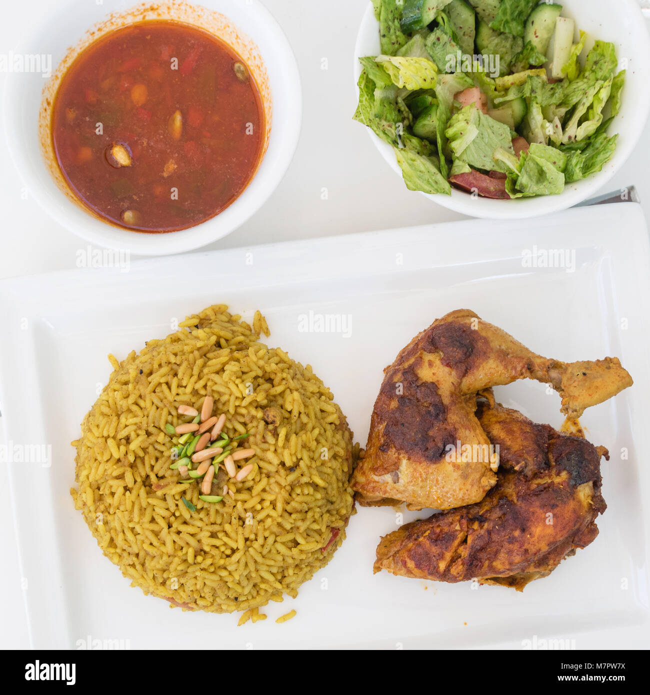 Fried chicken legs with rice accompanied with vegetable salad Stock ...