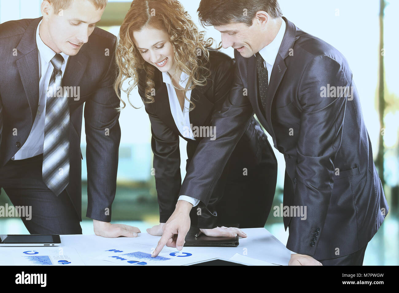 Business team working on their project together at the office a sunny ...