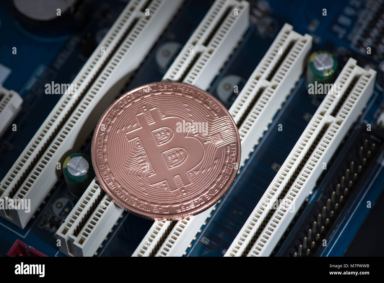 Bitcoin digital currency, bit-coin on motherboard or electronic board ...