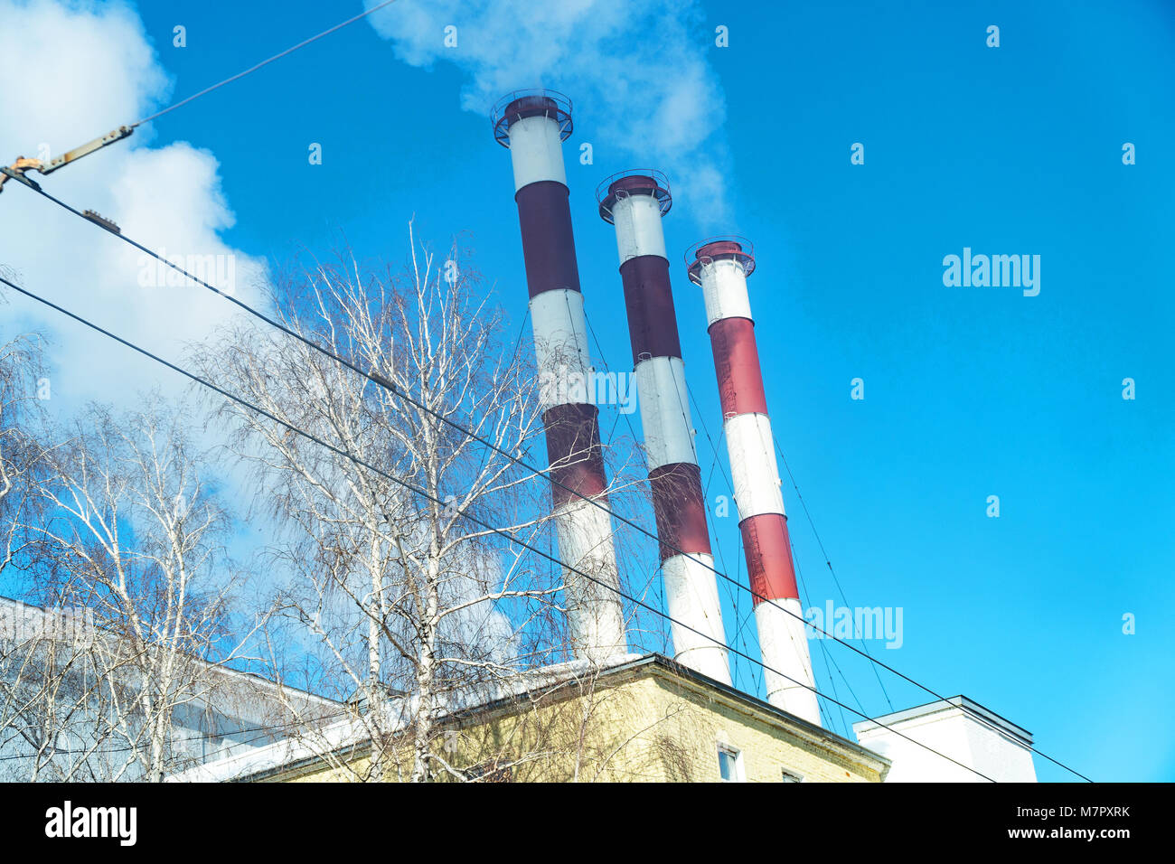 Three factory pipes smoke Stock Photo - Alamy
