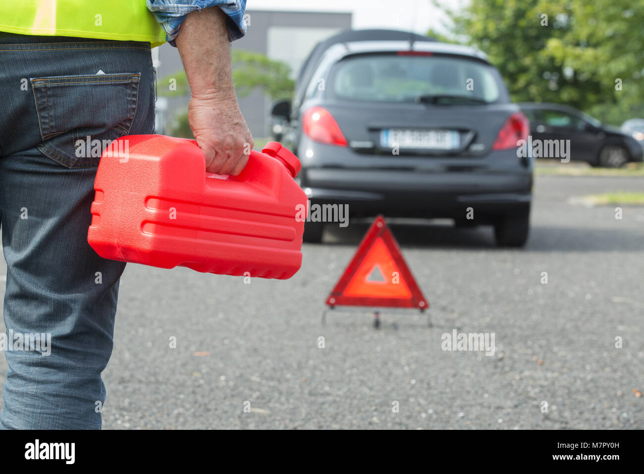 man holding gasoline canister Stock Photo - Alamy