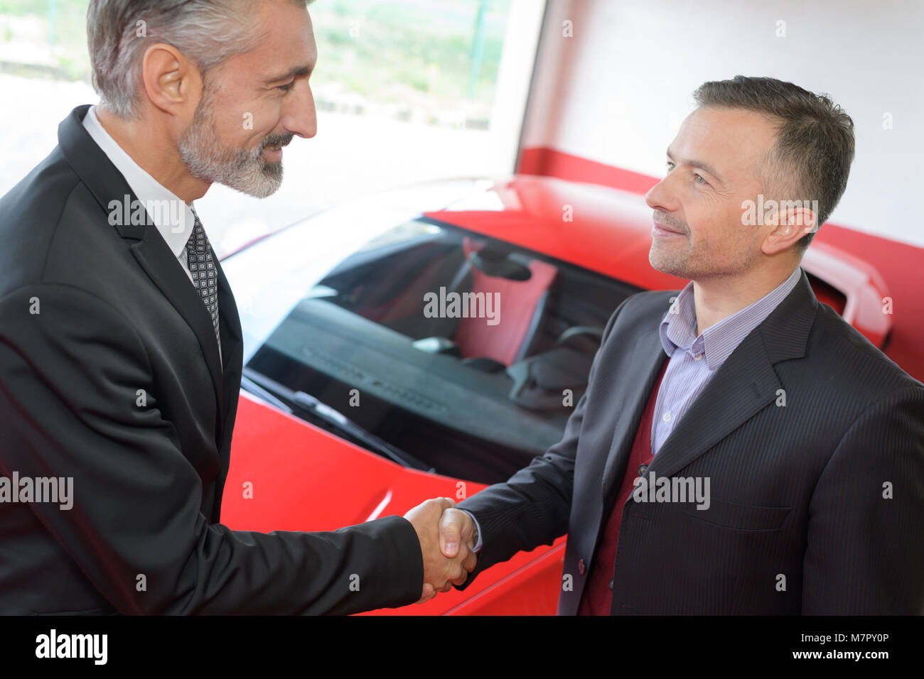 customer and salesman shaking hands Stock Photo - Alamy