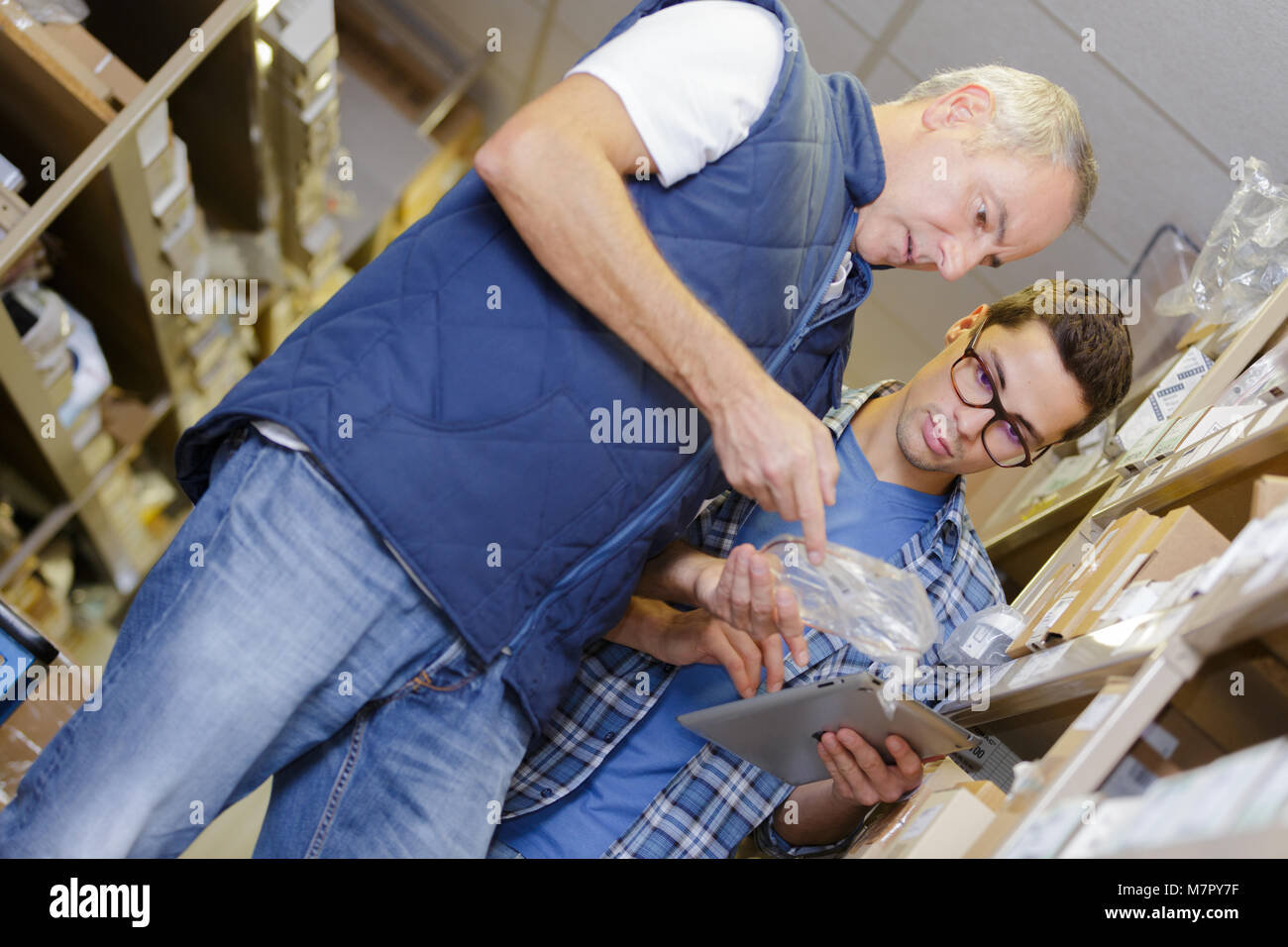 two men checking supply stock in the warehouse Stock Photo - Alamy