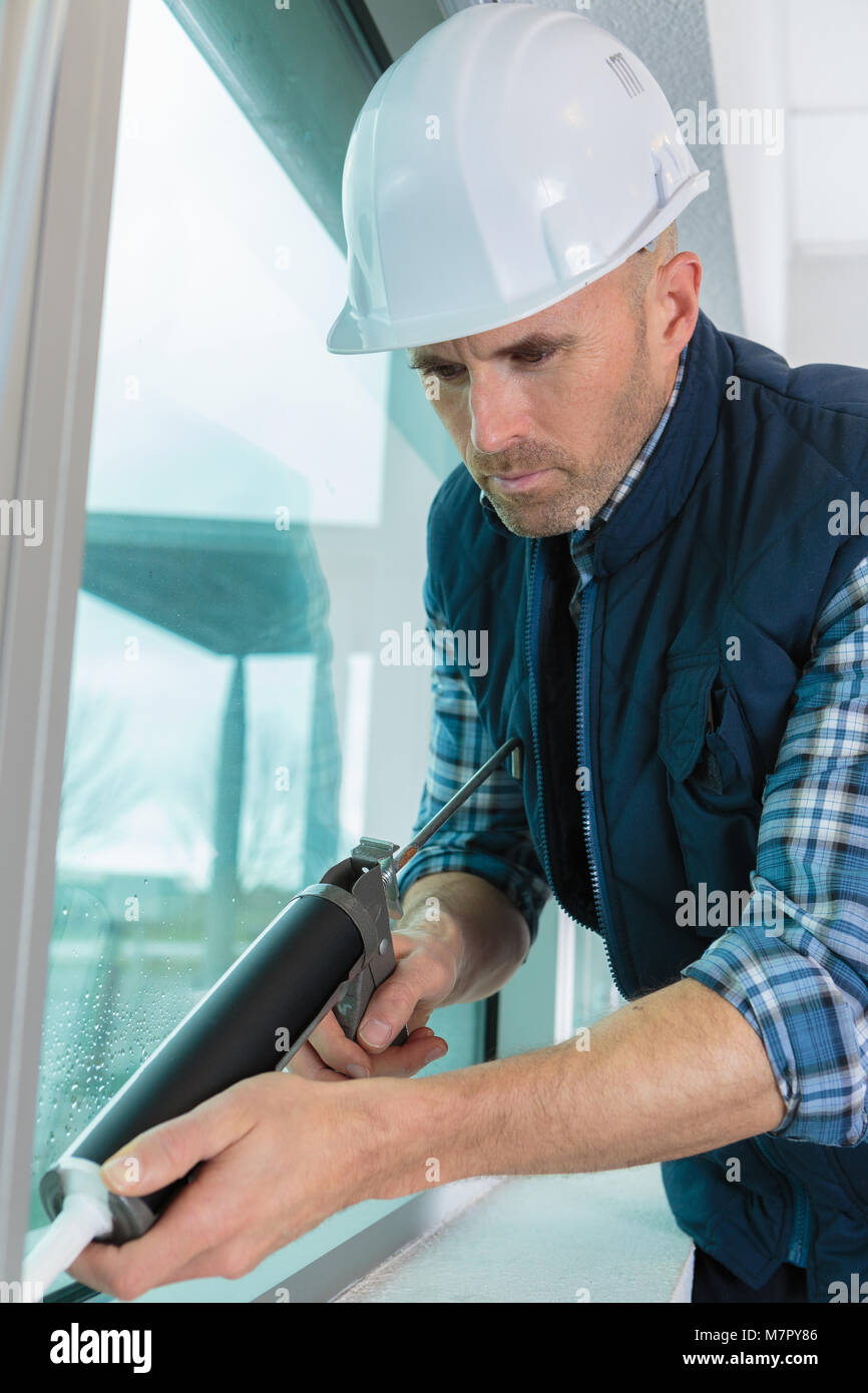 construction worker installing window in house Stock Photo - Alamy