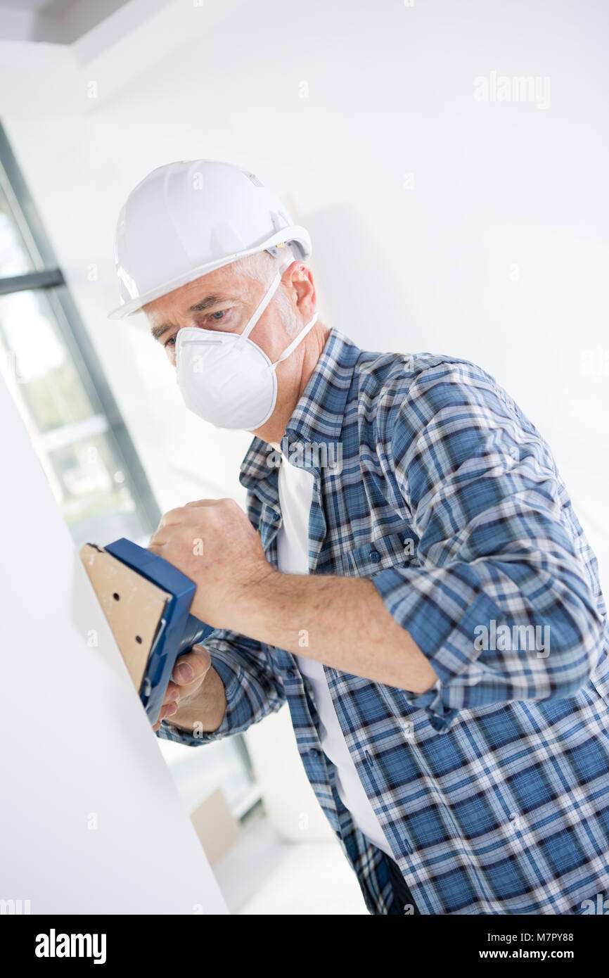 man sanding plasterboard Stock Photo - Alamy