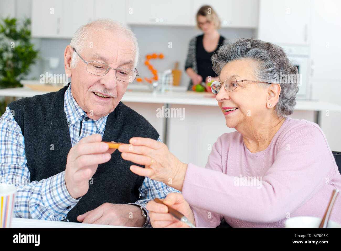happy elderly couple eating dinner Stock Photo - Alamy