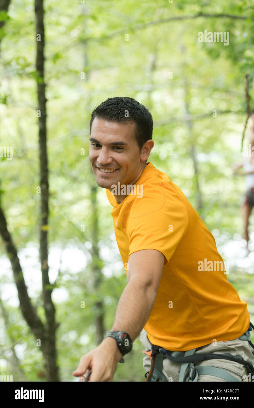 man in adventure park in forest Stock Photo - Alamy