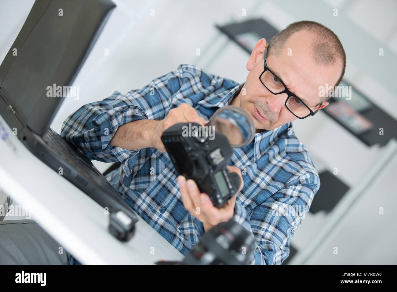 man photographer checking camera lens Stock Photo - Alamy