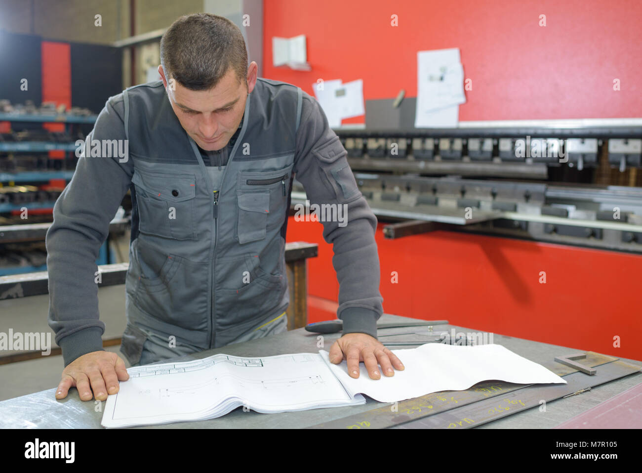 engineer in mechanical factory reading instructions Stock Photo - Alamy