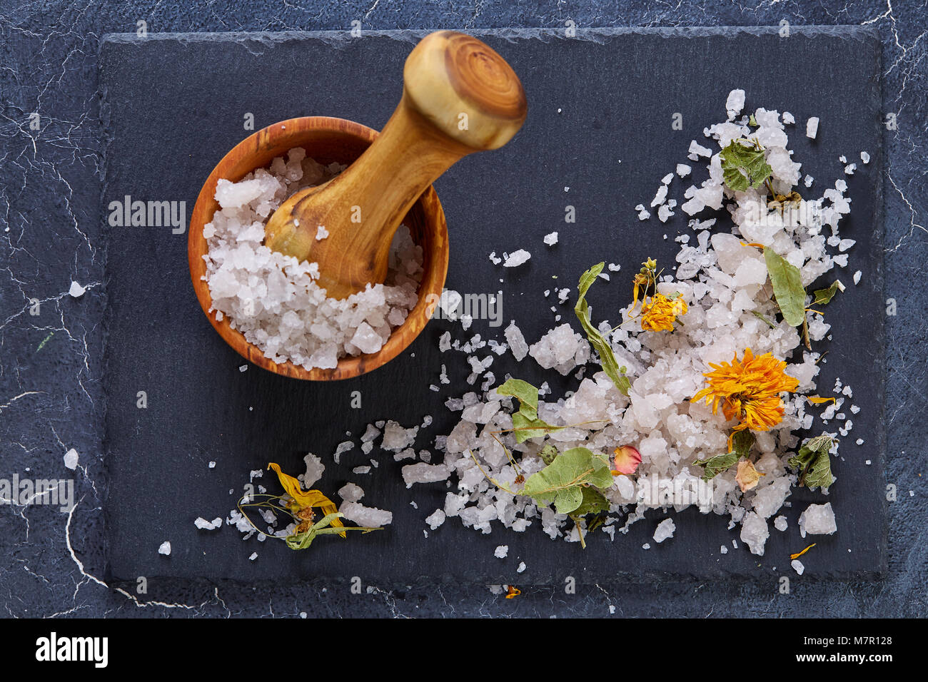 Pile of salt crystals mixed with motley grass and mortar and pestle on ...