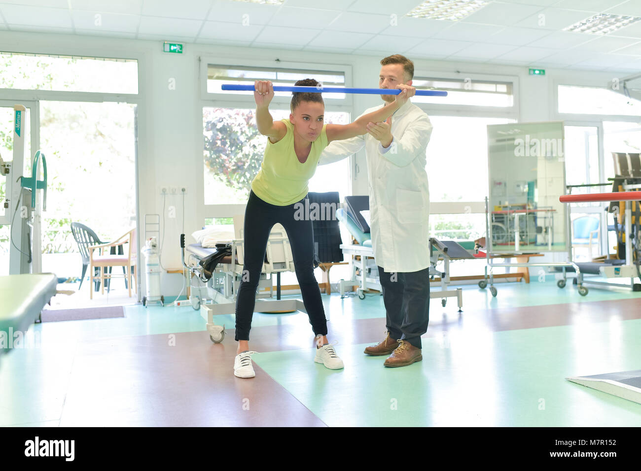 young woman patient doing physical exercises in a rehabilitation study ...
