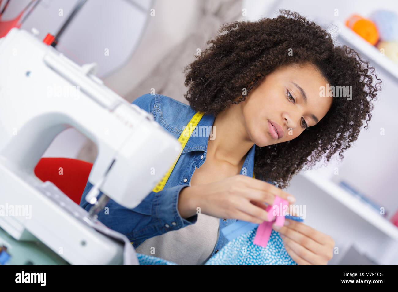 female dressmaker working with sewing machine Stock Photo - Alamy