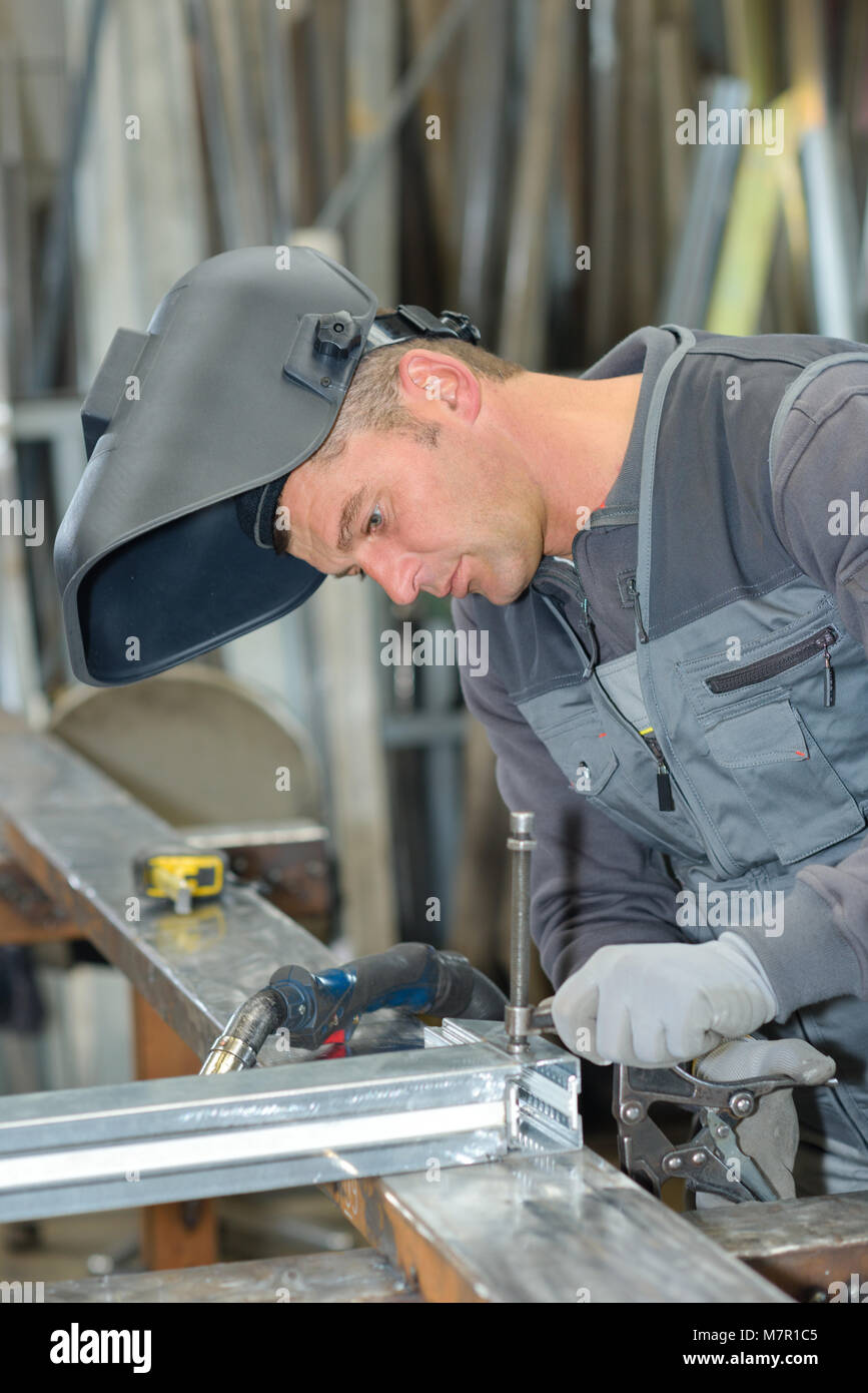 welder welded metal frame with a protective mask and gloves Stock Photo ...