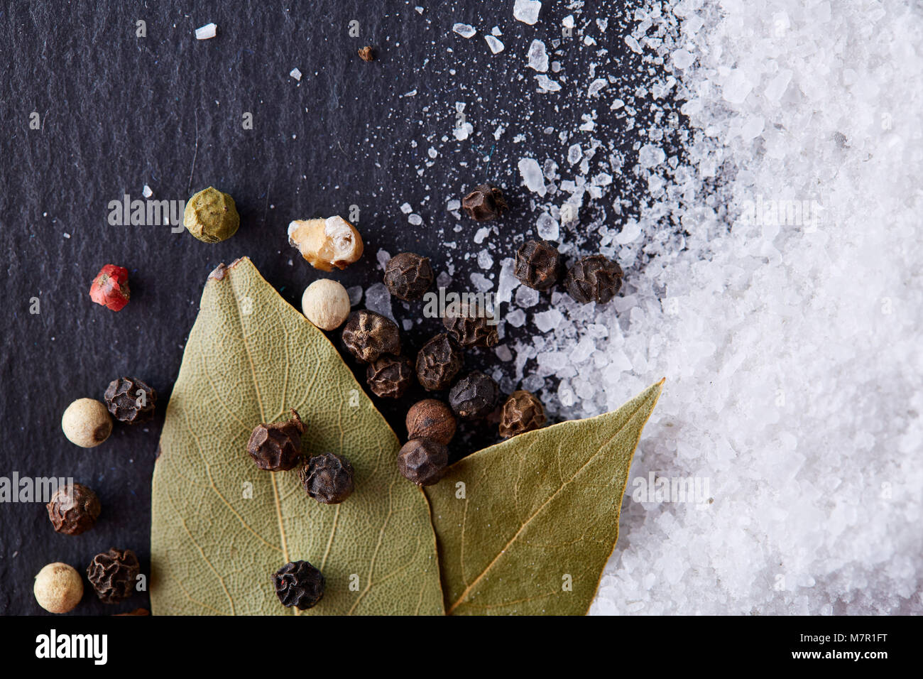 Composition of bay laurel leaf with peppercorn and salt isolated on ...