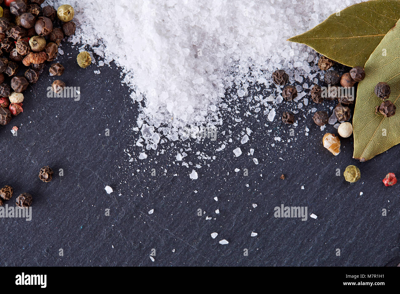 Composition of bay laurel leaf with peppercorn and salt isolated on ...