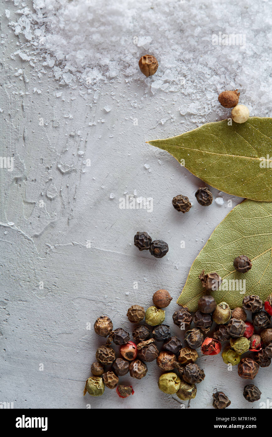 Composition of bay laurel leaf with peppercorn and salt isolated on ...