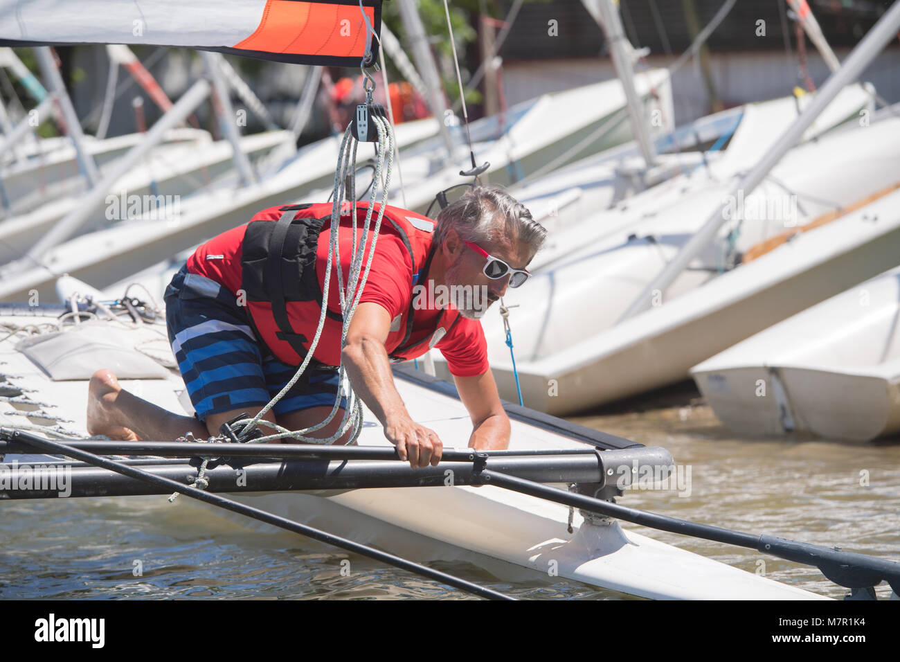professional waterman training on lake with catamaran Stock Photo - Alamy