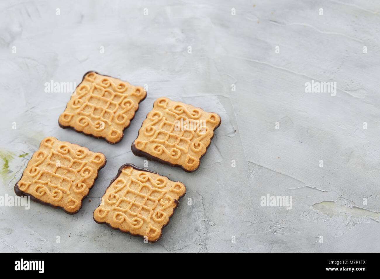 Square cookies arranged in pattern on light textured background, close ...