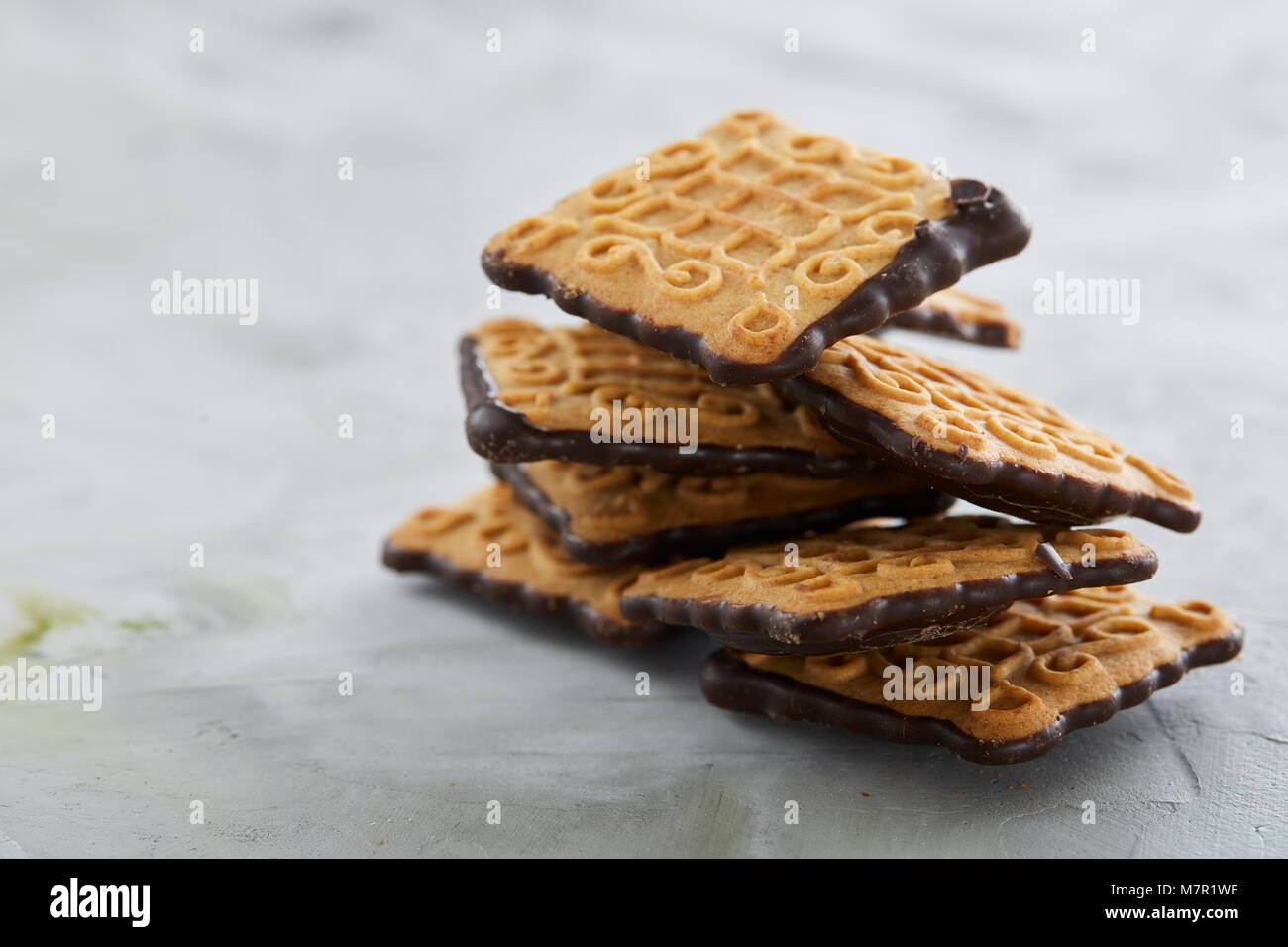 Square cookies arranged in pattern on light textured background, close ...
