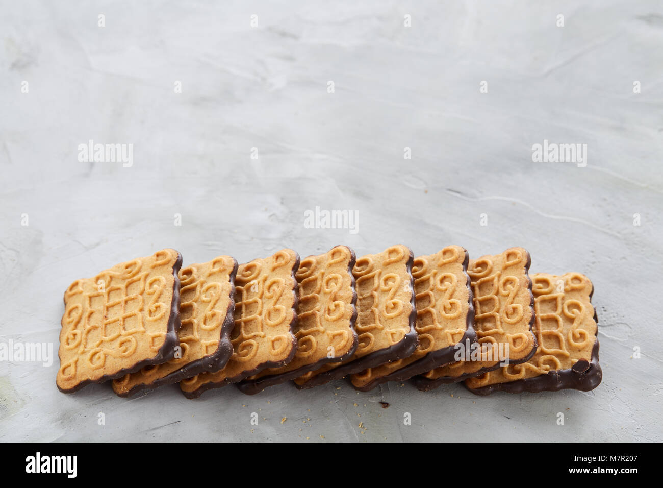 Square cookies arranged in pattern on light textured background, close ...