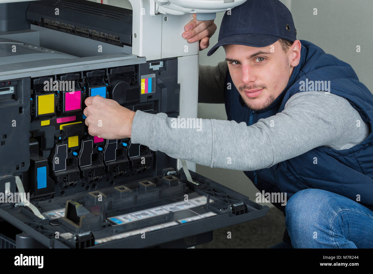 Man replacing ink cartridges in photocopier Stock Photo - Alamy
