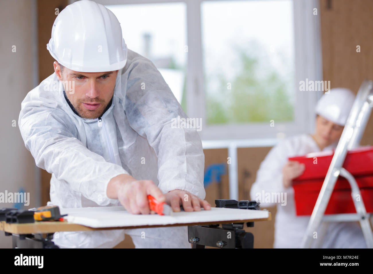 handyman using cutter at building site Stock Photo - Alamy