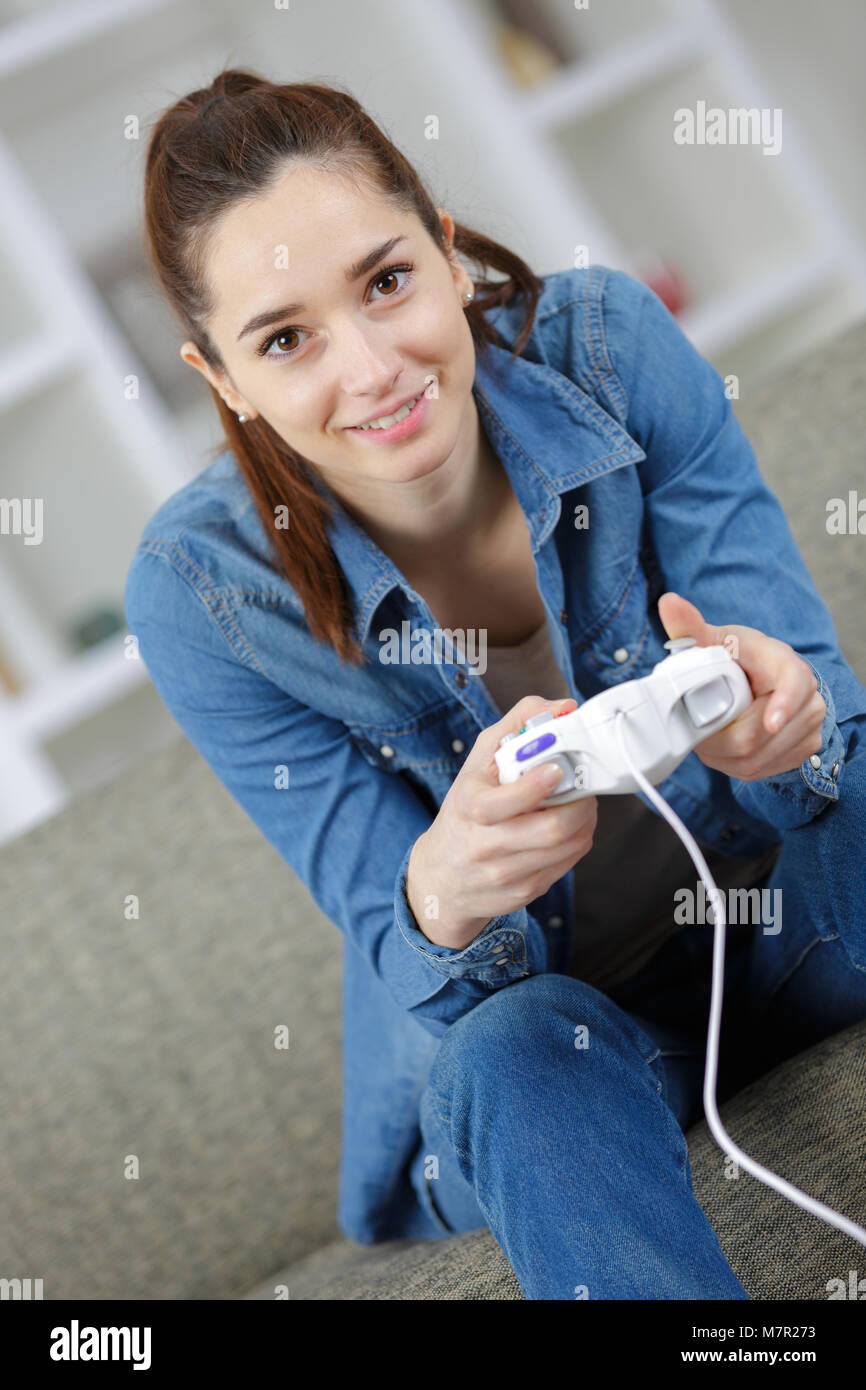 cheeful girl playing video games alone Stock Photo - Alamy