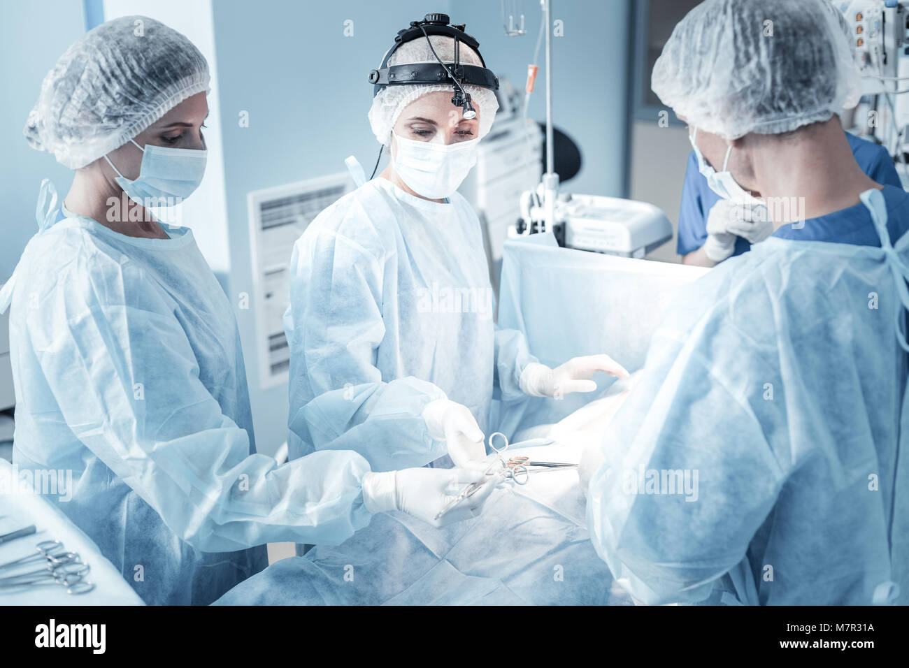 Concentrated occupied surge standing and taking a clamp Stock Photo - Alamy