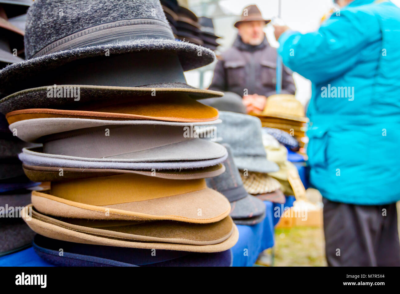 Stacked various colored men hats for sale, available at flea market ...