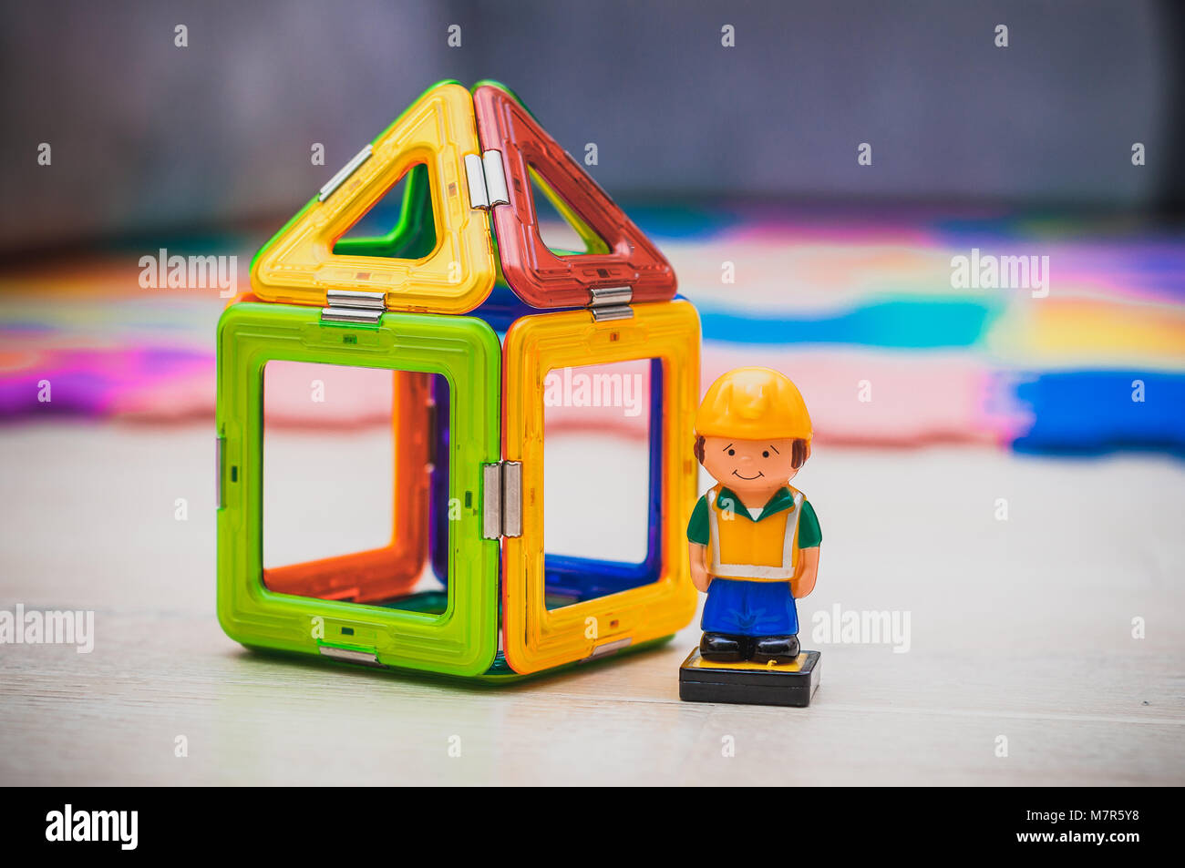 Construction worker and building industry concept. Toy house miniature ...