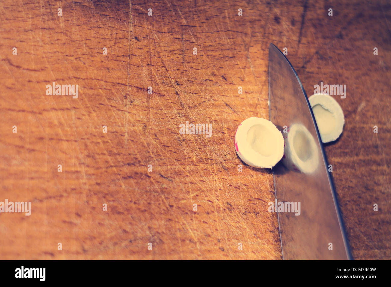 The empty white chewing gum is cut in half with a kitchen knife Stock ...