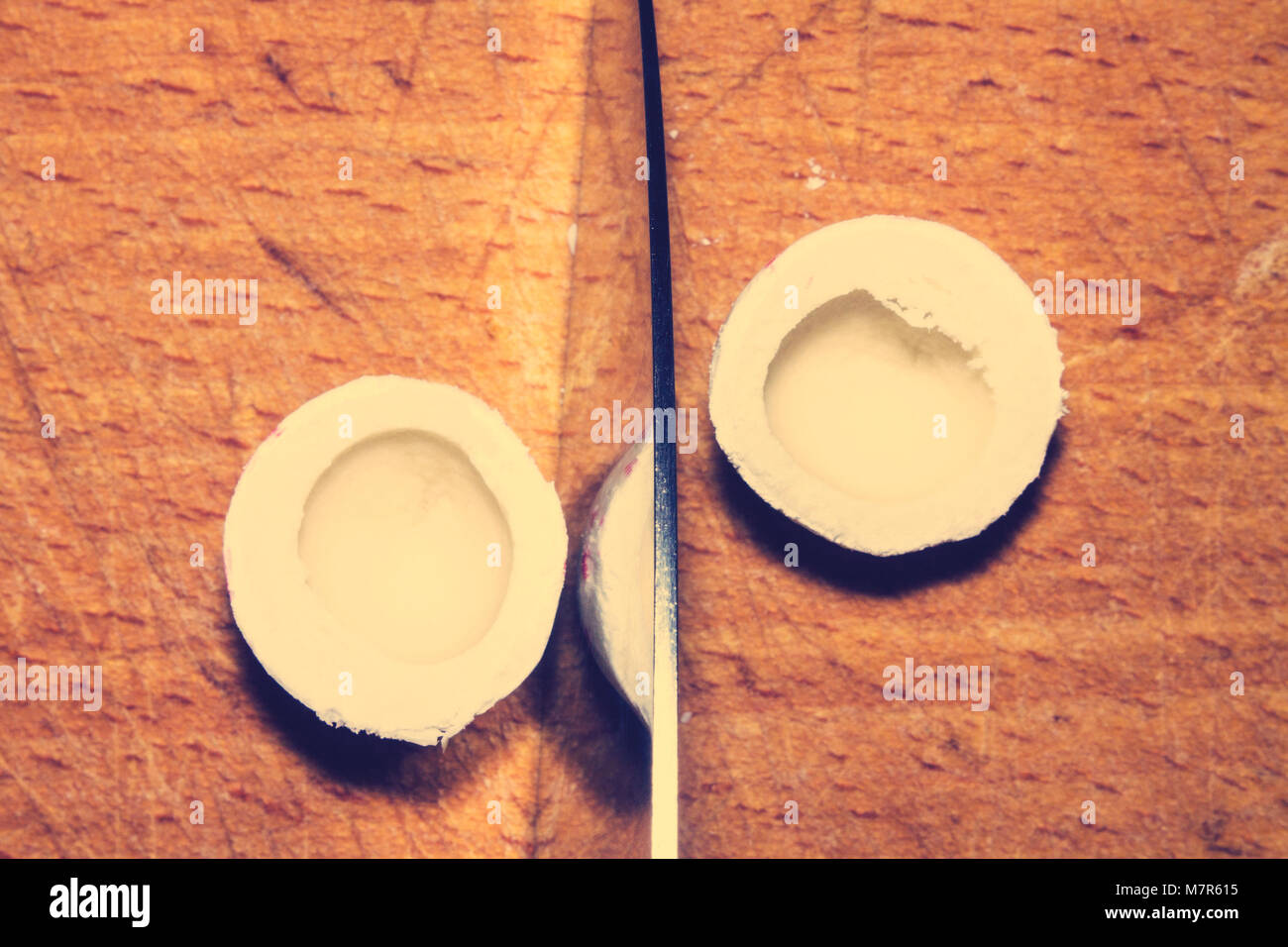 The empty white chewing gum is cut in half with a kitchen knife Stock ...