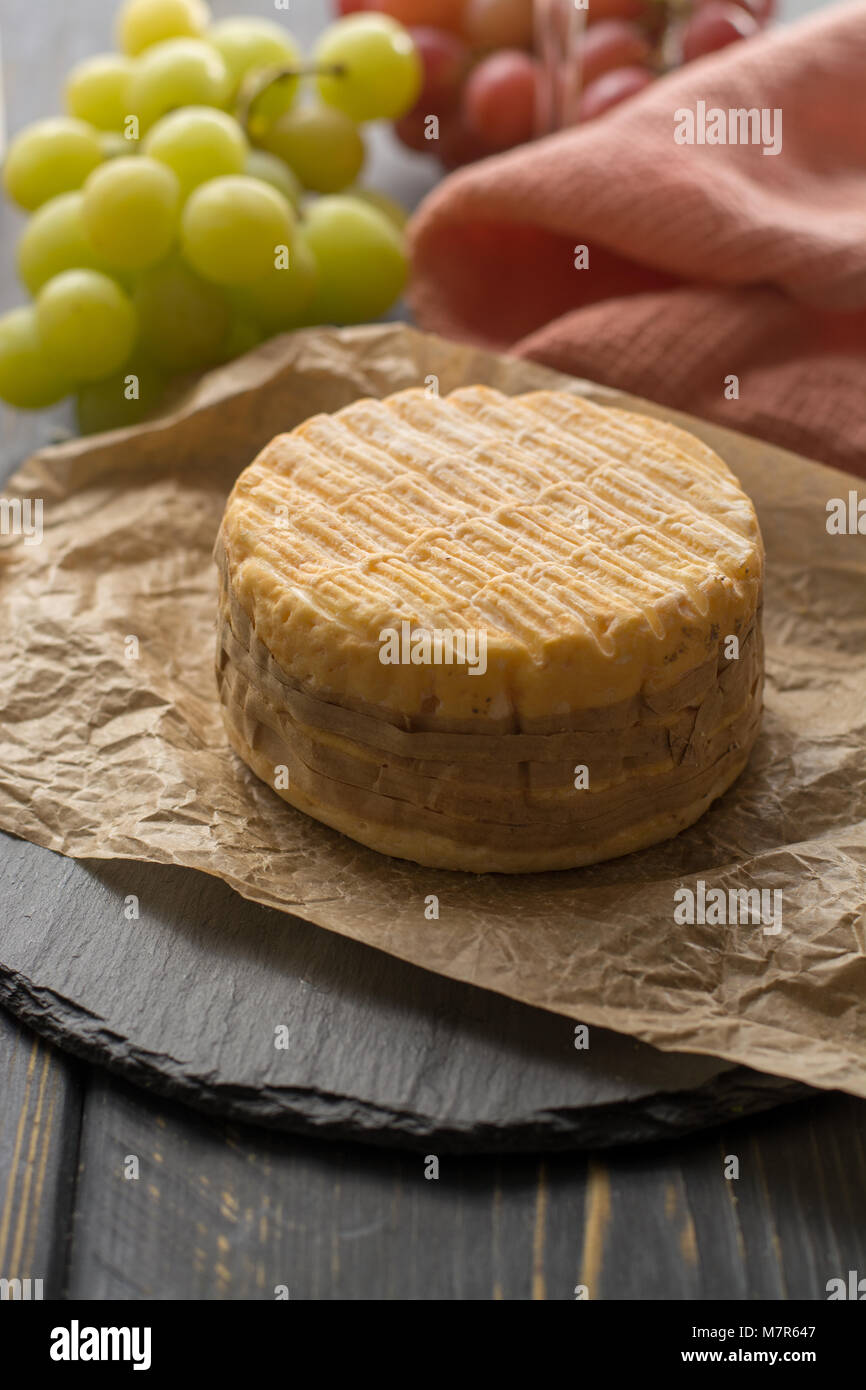 Tasting of oldest french AOC soft pudgent wrapped yellow cheese Livarot ...