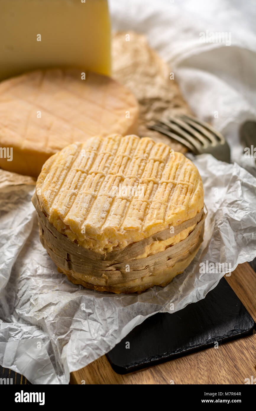 Tasting of oldest french AOC soft pudgent yellow cheese Livarot and ...