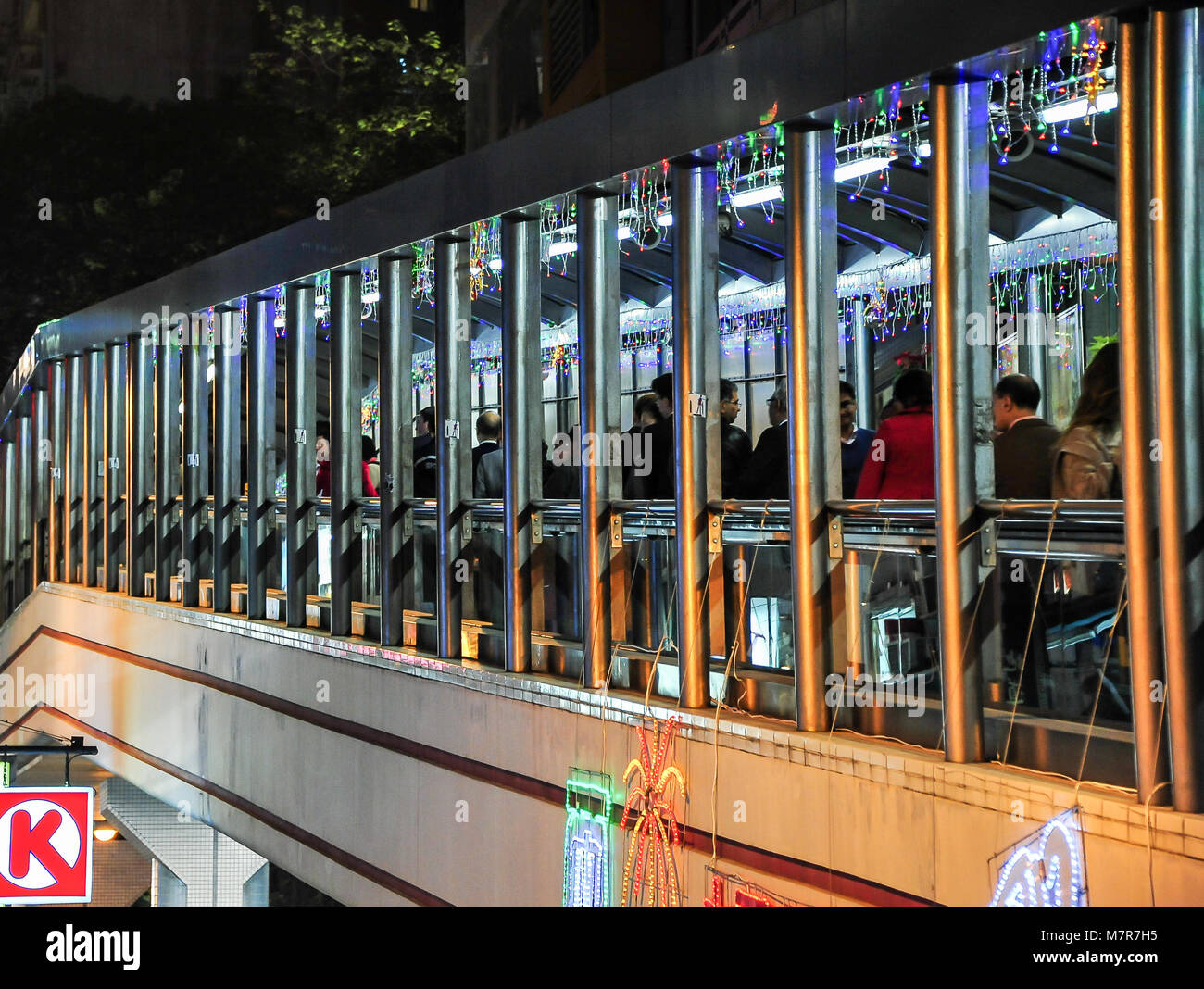 Hong Kong: End of the day, people on the move on an overhead walkway in ...