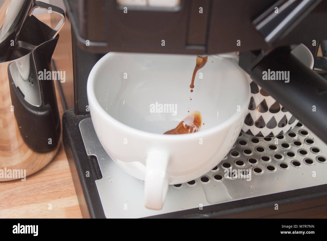 Fresh coffe pouring out of an espresso machine Stock Photo - Alamy