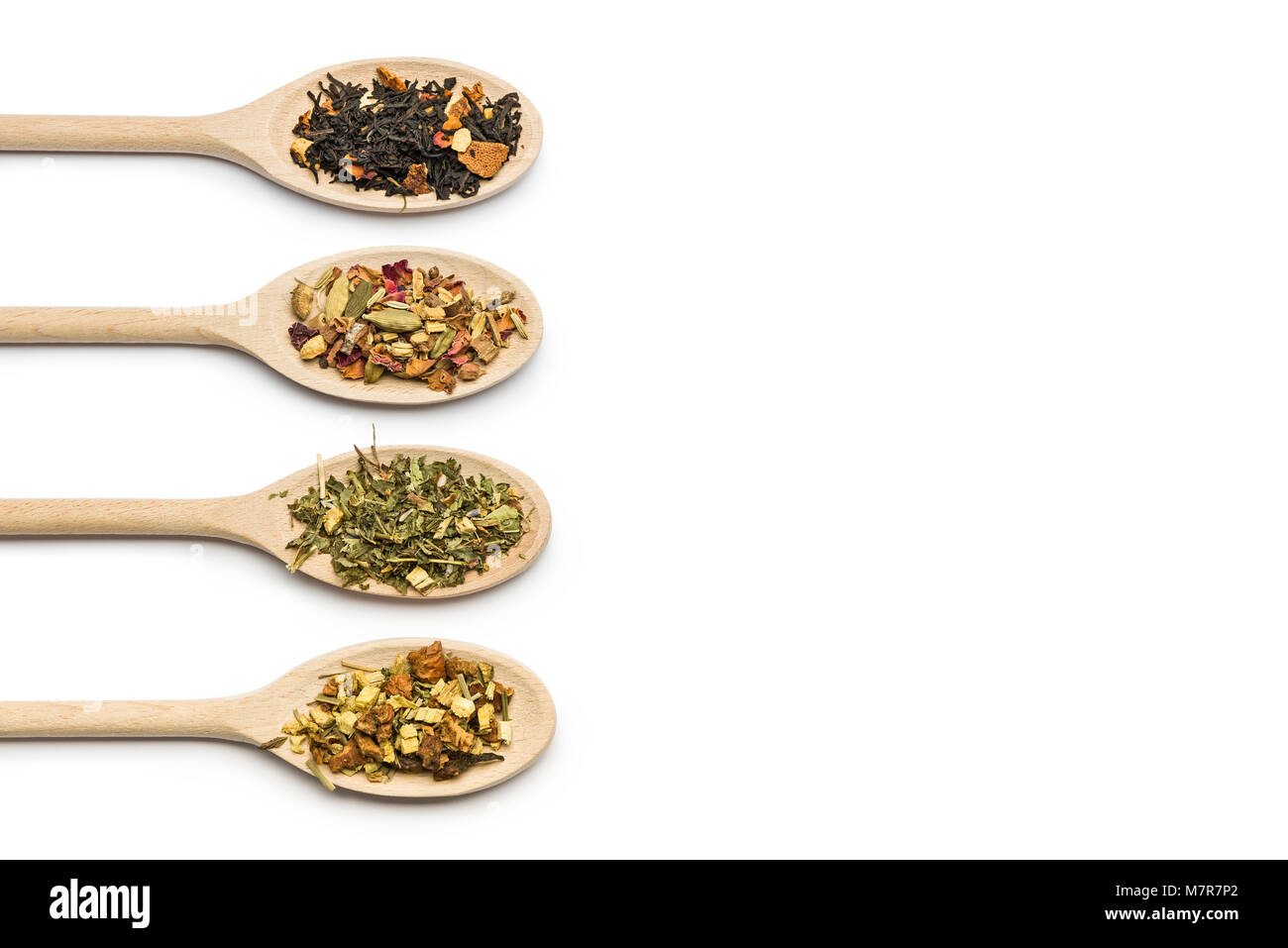 variety of tea blend on wooden spoon on white background with copy ...