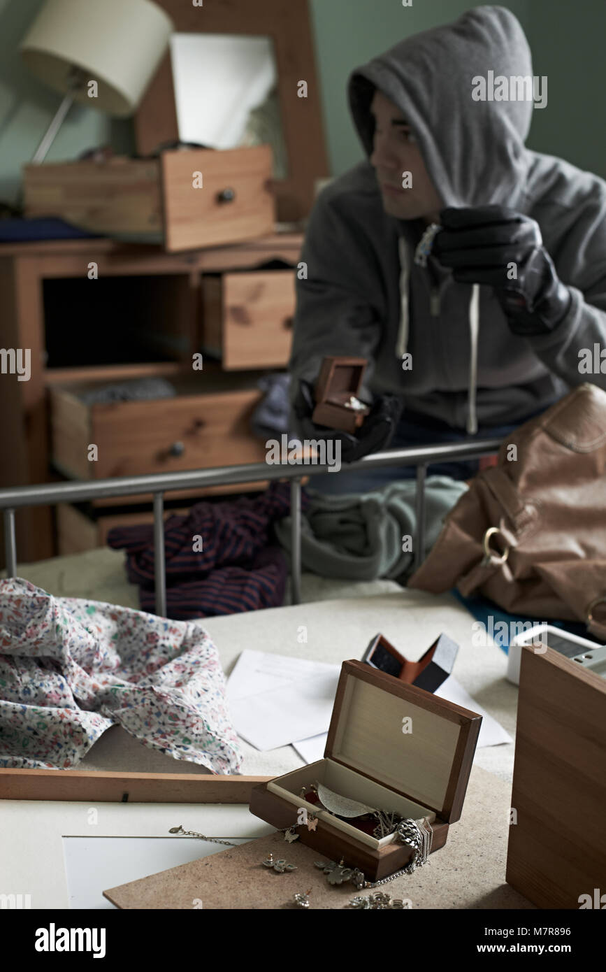 Burglar Stealing Items From Bedroom During House Break In Stock Photo ...