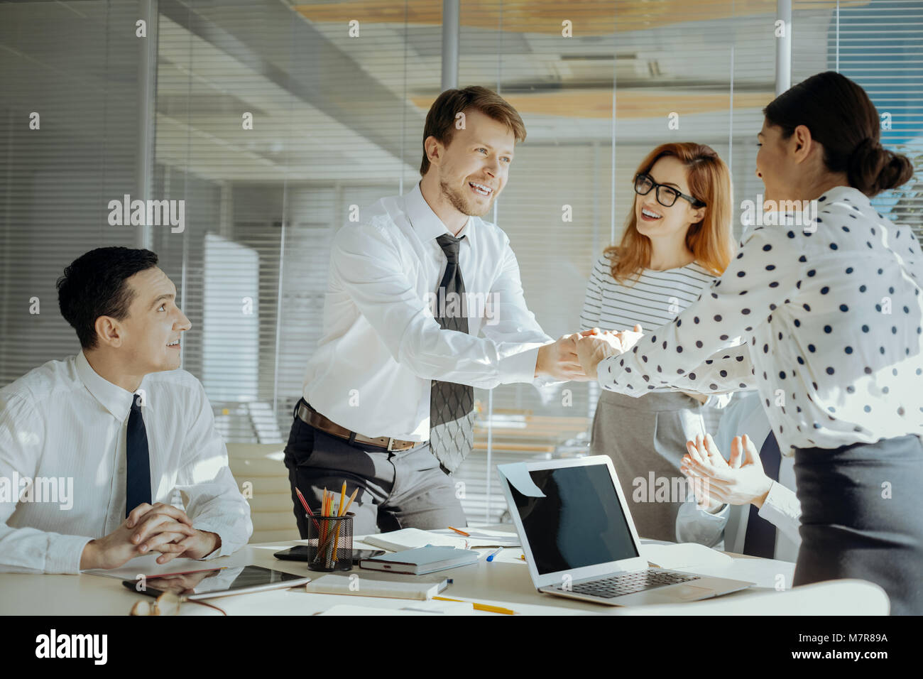Pleasant smiling boss shaking hands with his colleague Stock Photo - Alamy
