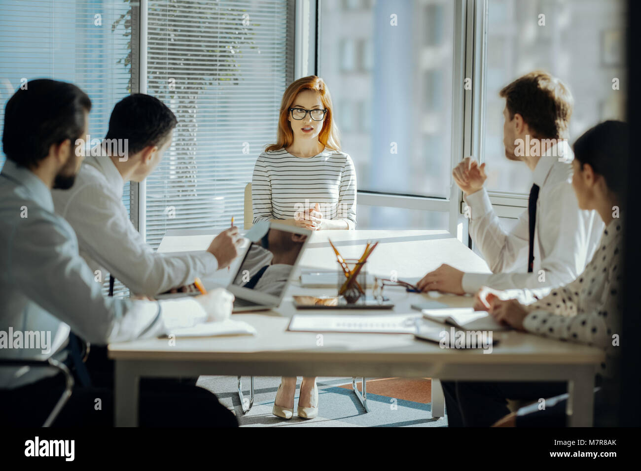 Female boss developing project plan with her employees Stock Photo - Alamy