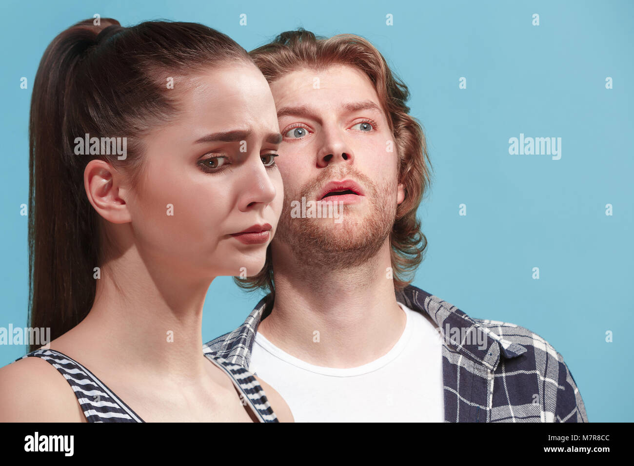 Depressed couple. Depressed young couple standing close to each other ...