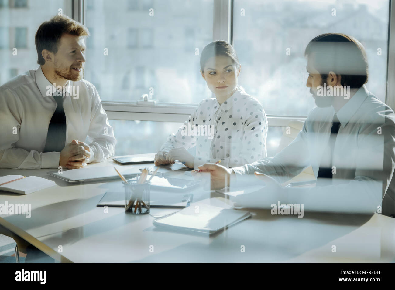 Two colleagues reporting to their boss in his office Stock Photo - Alamy