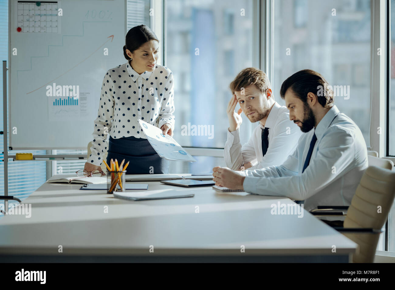 Angry female boss reprimanding her employees during meeting Stock Photo ...
