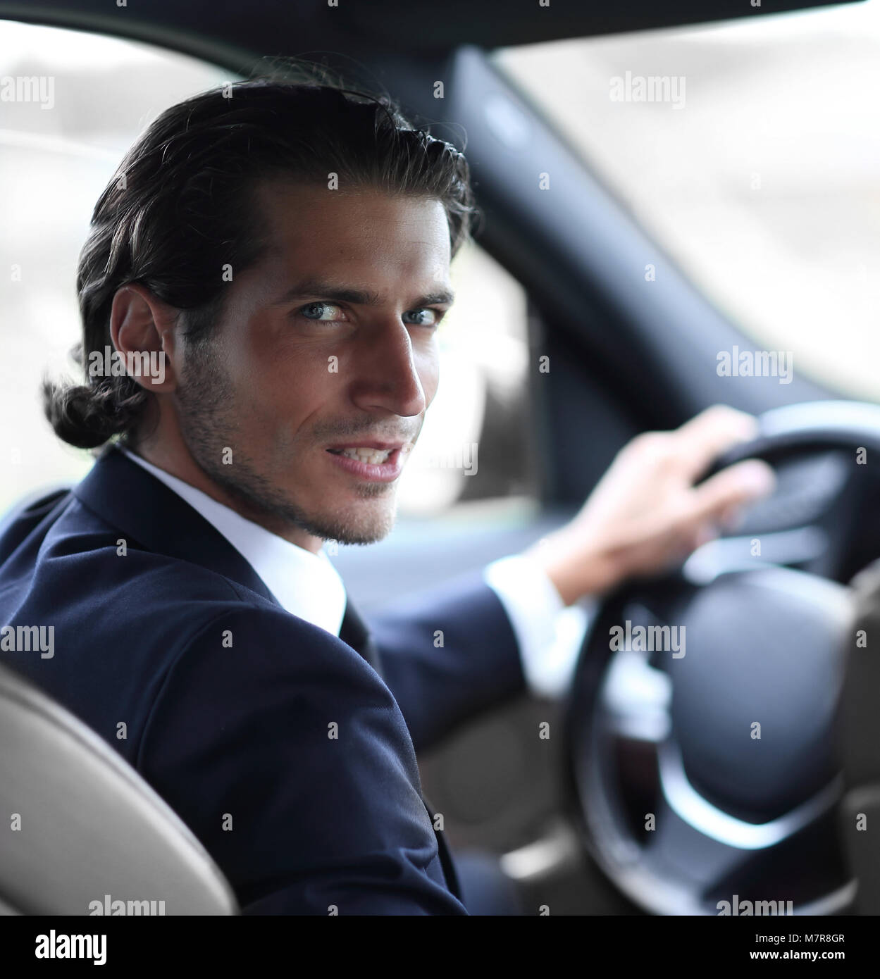 man sitting behind the wheel of a car Stock Photo - Alamy