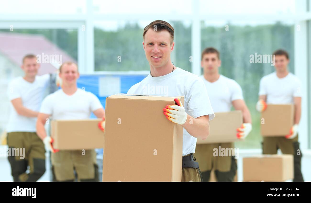 foreman and workers with boxes of building materials Stock Photo - Alamy