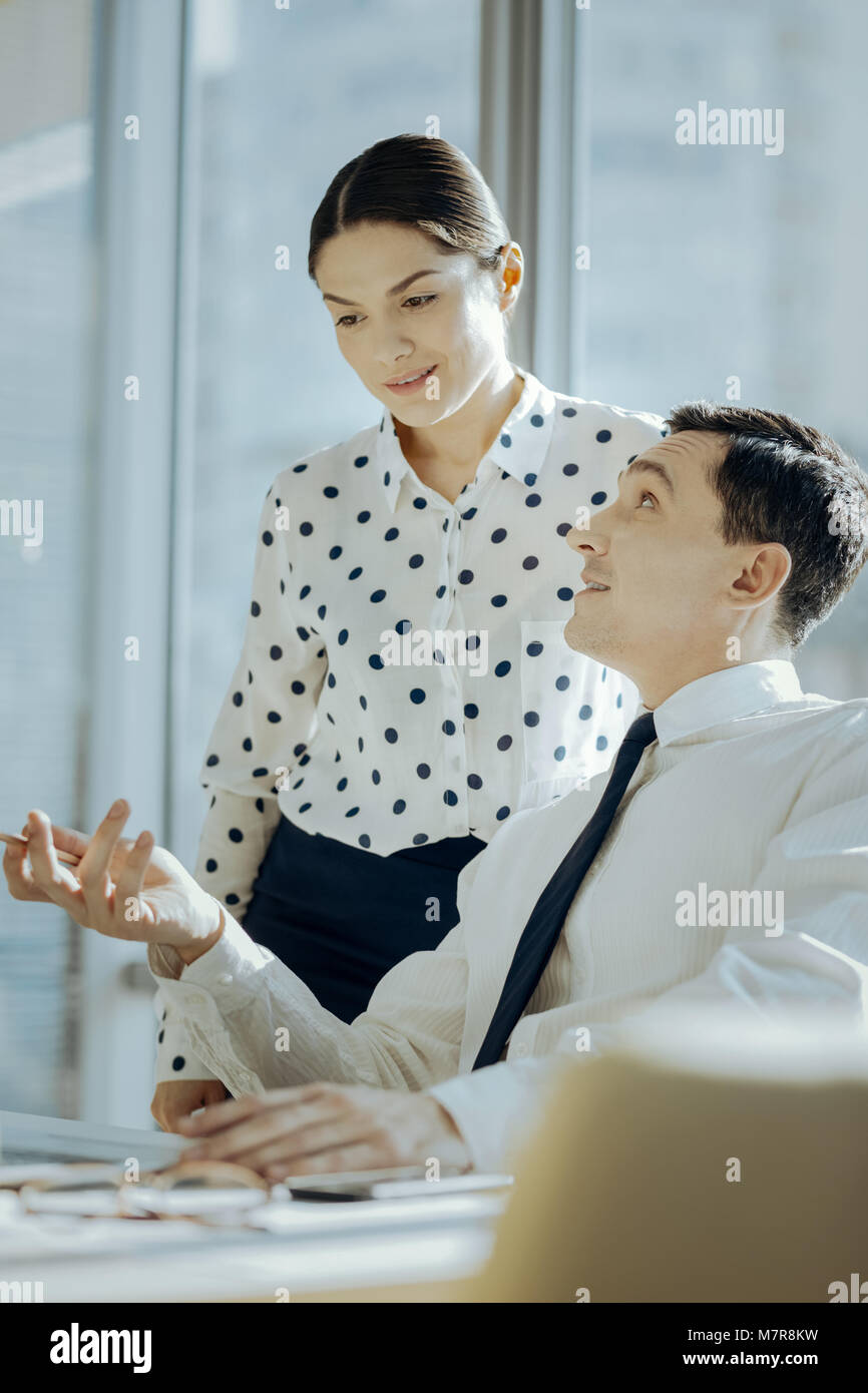 Pleasant man asking his boss opinion about his work Stock Photo - Alamy