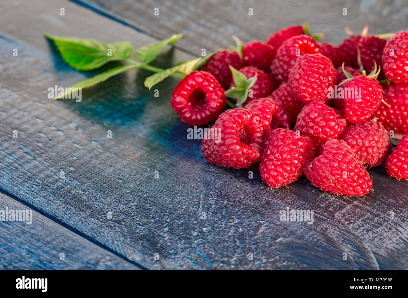 Raspberries on rustic wooden board. Wooden background with raspberry ...