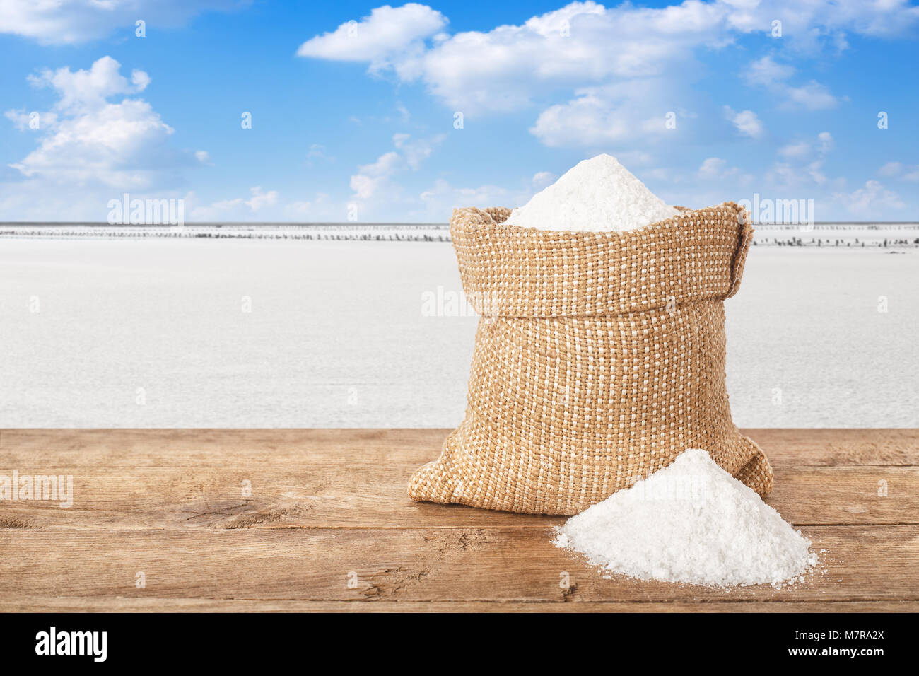 salt in bag. Crystals of salt in sack on table with salty lake in the ...